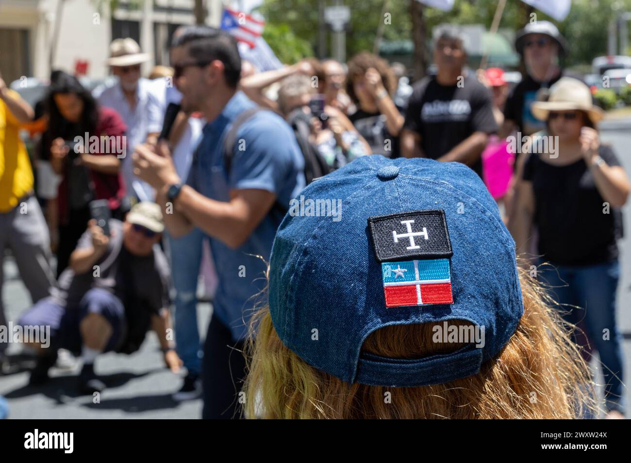 San Juan, USA. 01st Apr, 2024. A woman wearing a cap with patches of ...
