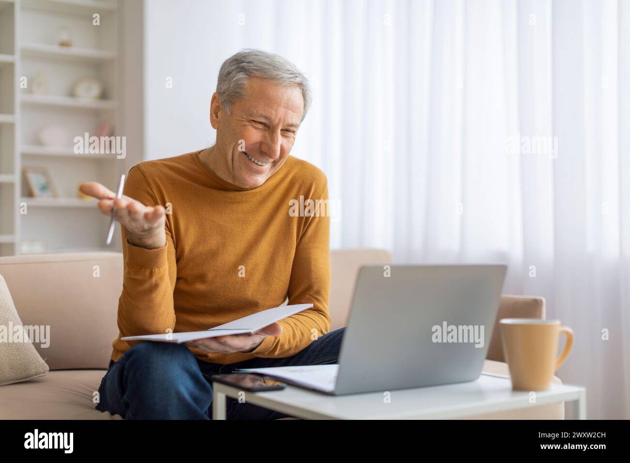 Senior explaining with hand gesture during call Stock Photo - Alamy