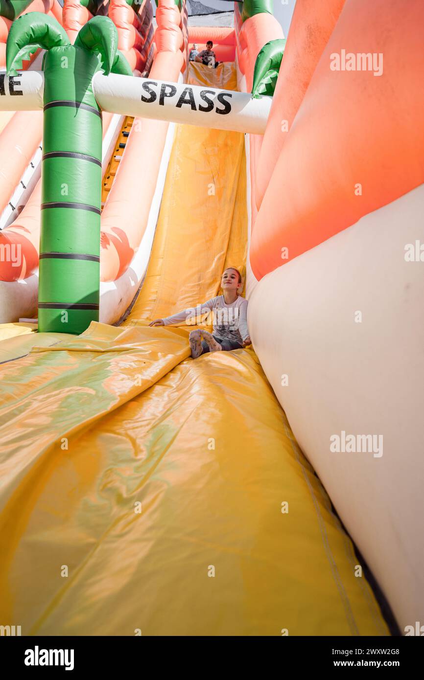 Bad Gleichenberg, Austria - March 30th 2024 - A girl on an inflatable ...