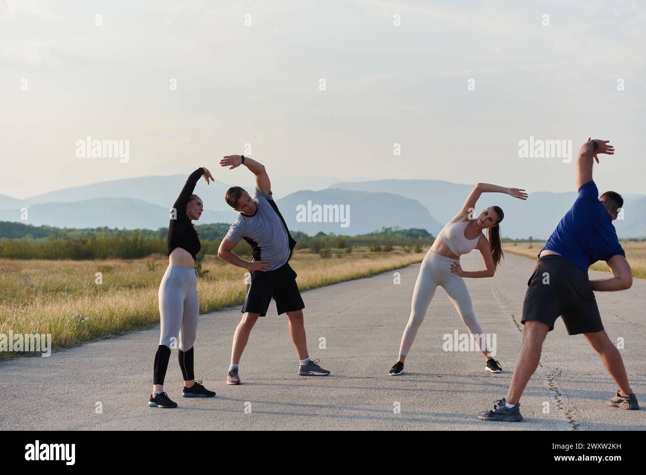 Diverse Group of Athletes Prepare Together for a Run Stock Photo - Alamy