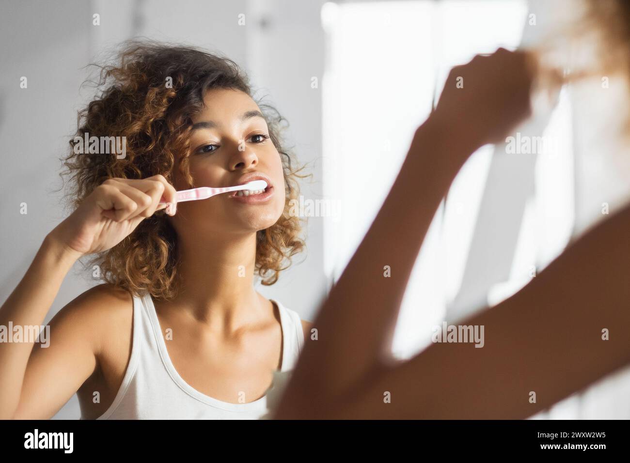 Afro Woman Brushing Teeth In Bathroom, Panorama Stock Photo - Alamy