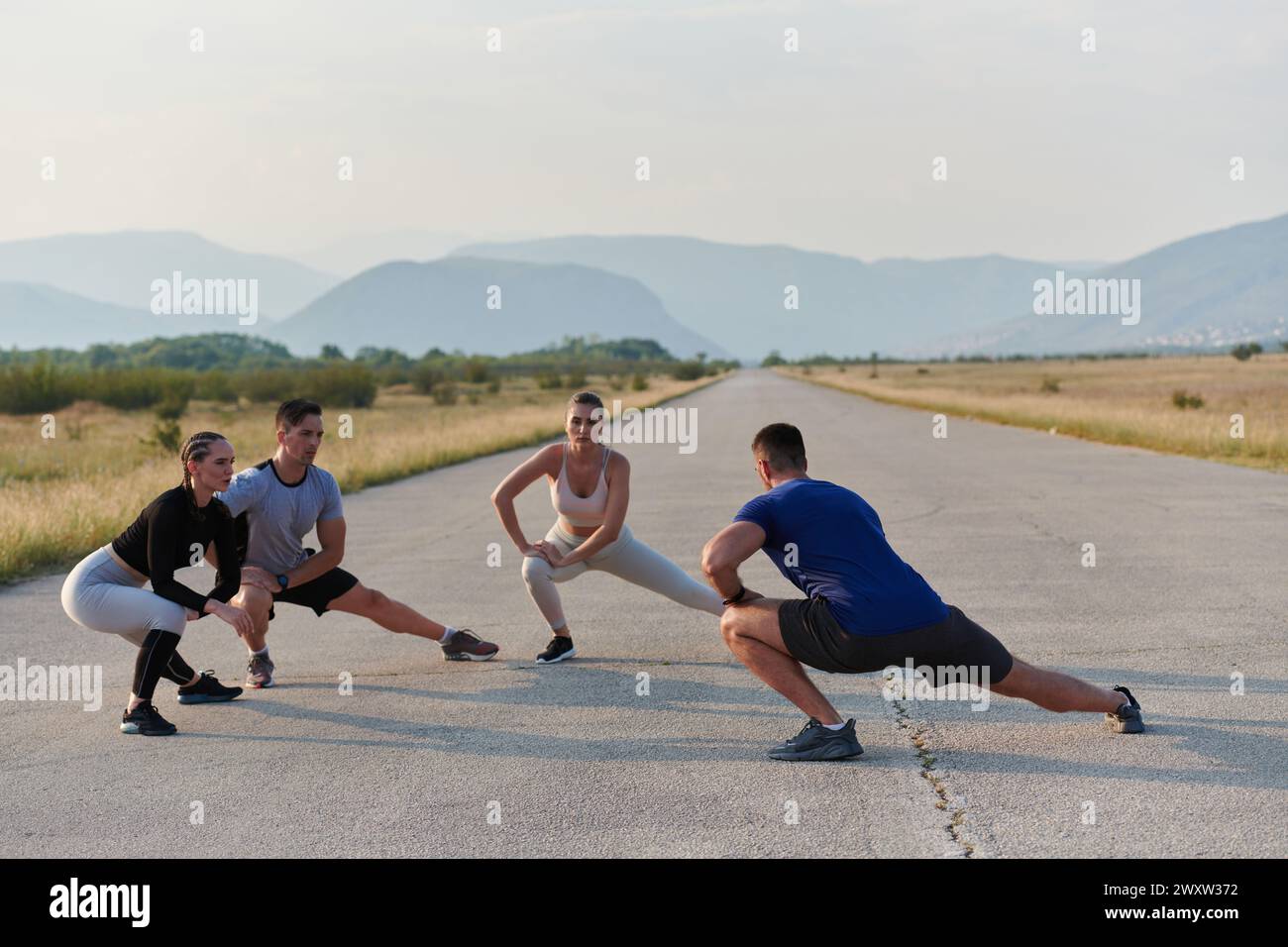 Diverse Group of Athletes Prepare Together for a Run Stock Photo - Alamy