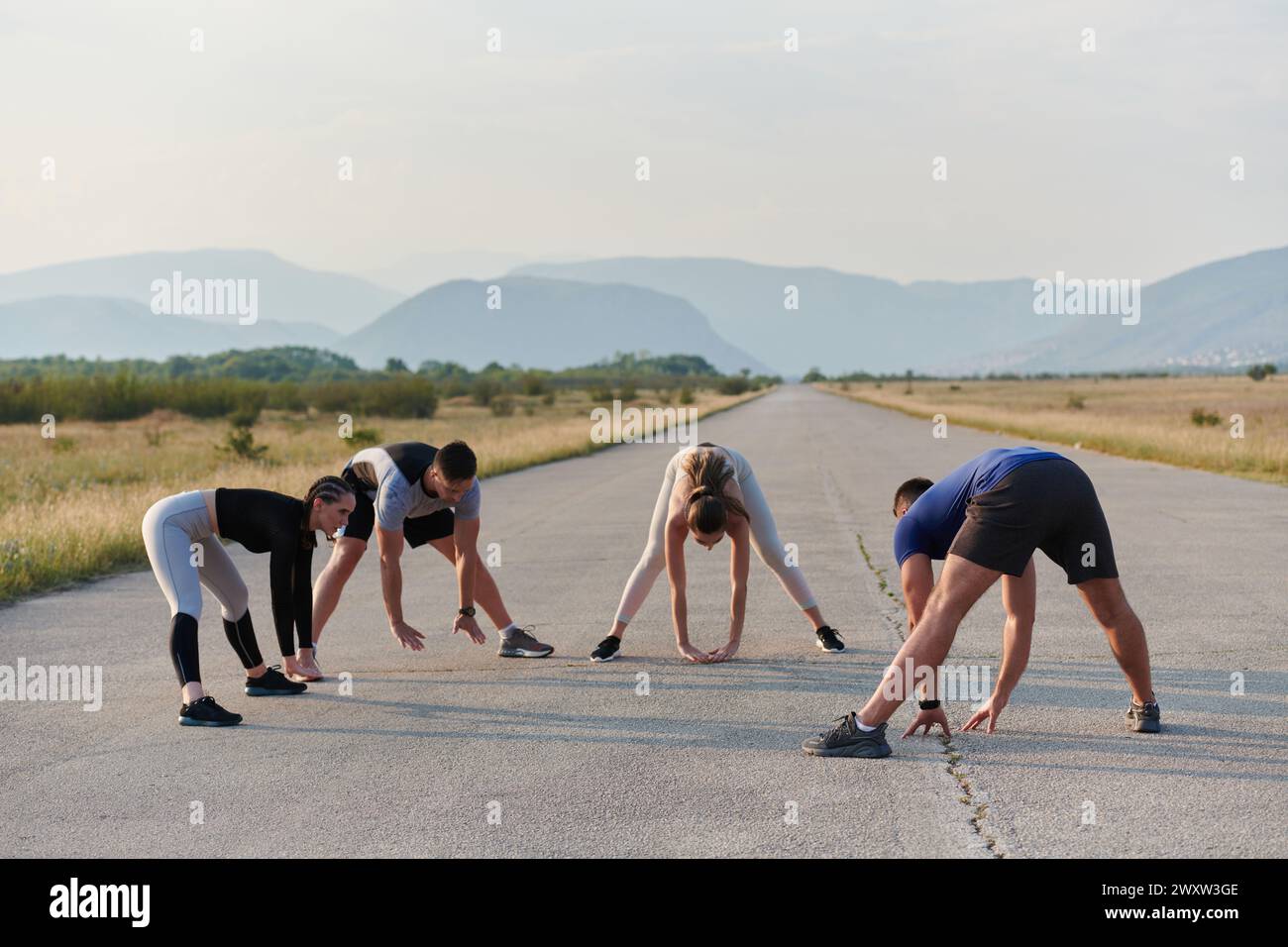 Diverse Group of Athletes Prepare Together for a Run Stock Photo - Alamy