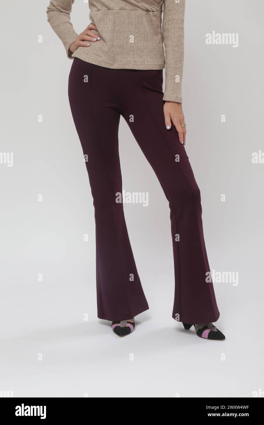 Serie of studio photos of young female model wearing basic flared ...