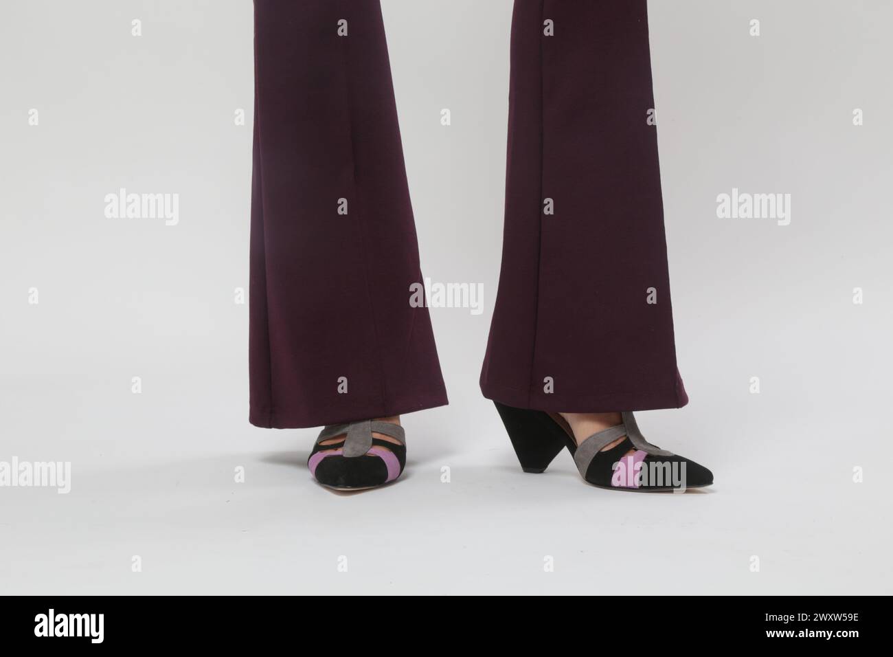 Serie of studio photos of young female model wearing basic flared ...