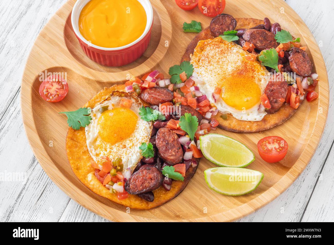 Chorizo and egg tostadas with cheddar cheese sauce Stock Photo - Alamy