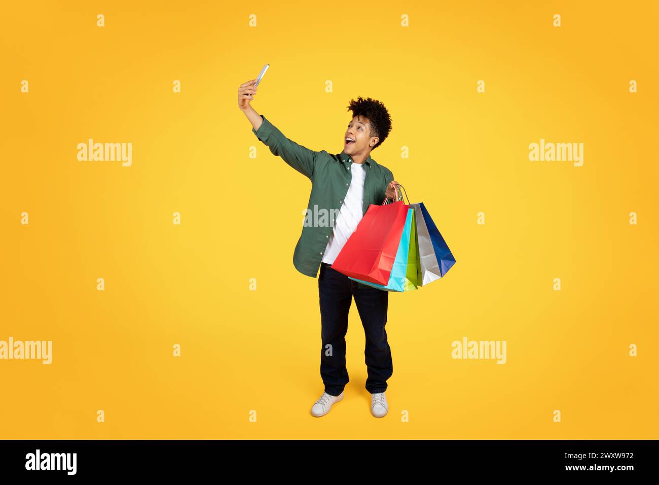 Happy shopper african american guy with bags taking a selfie Stock ...