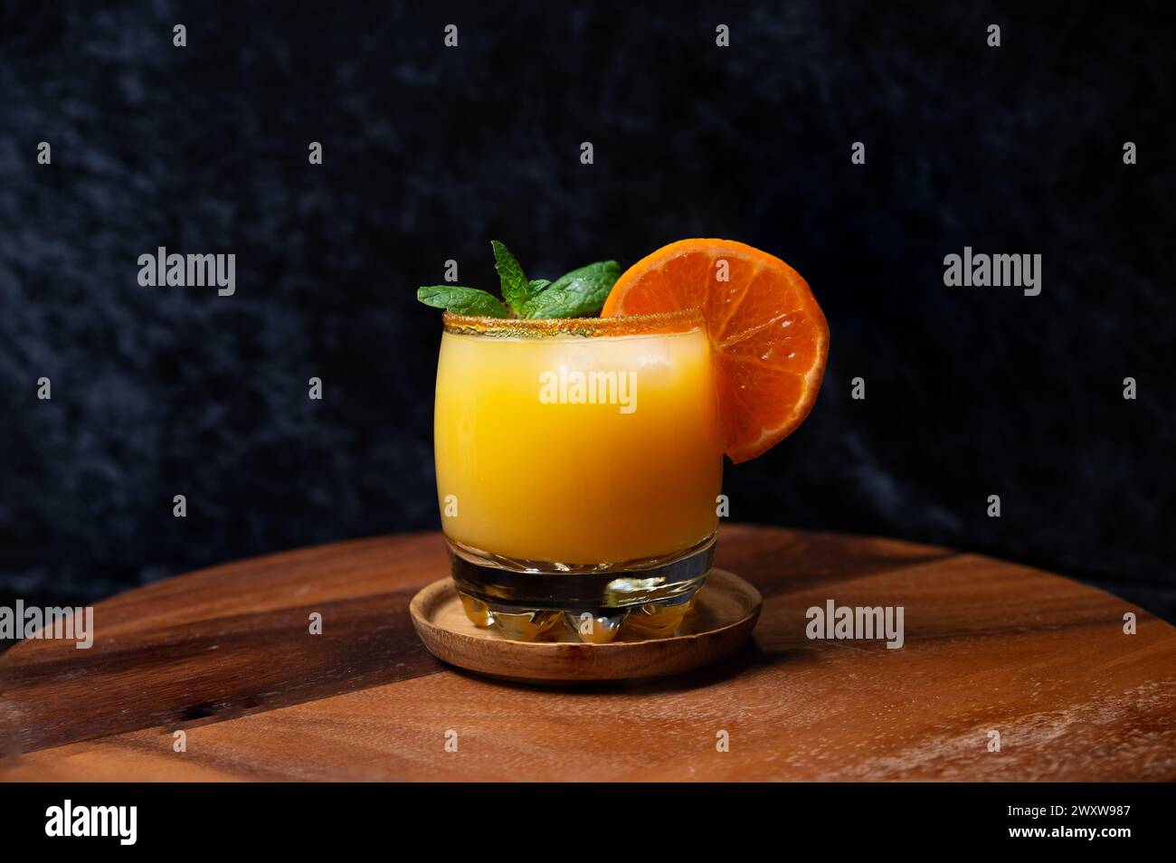 Whiskey Sour. hiskey and orange juice cocktail on an brown sugar rimmed ...