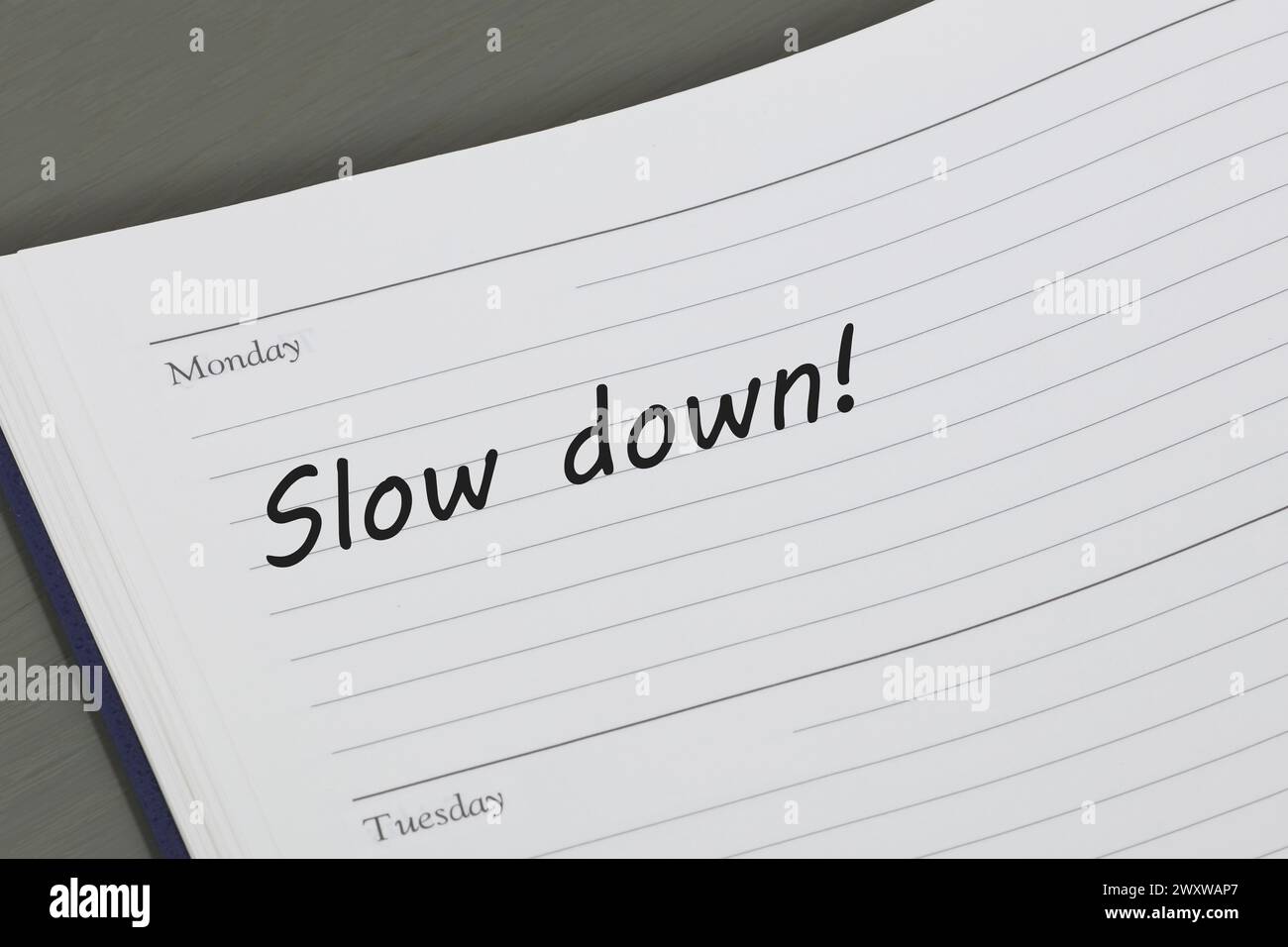 Slow down reminder message in an open diary Stock Photo - Alamy