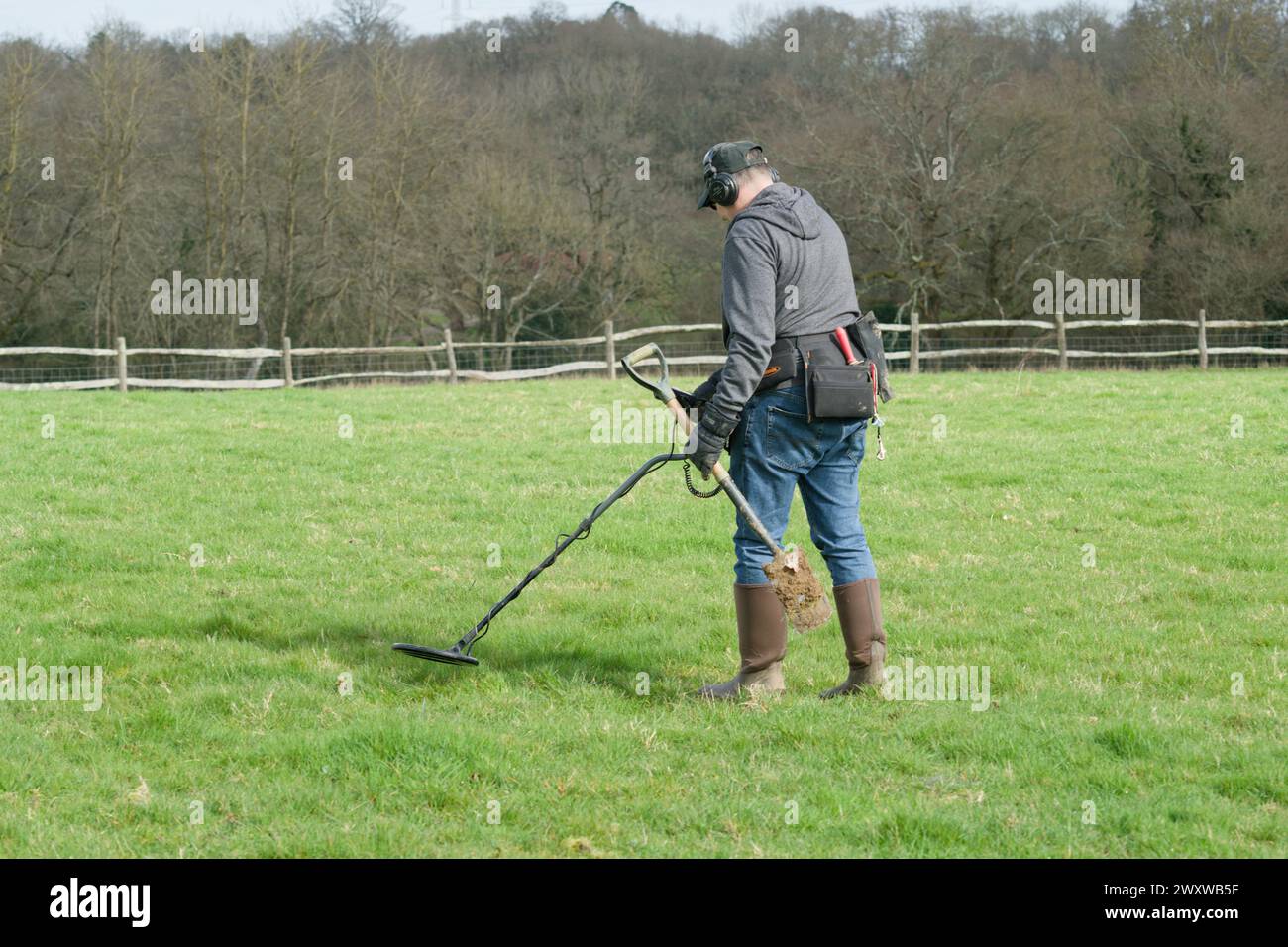 A Metal Detectorist In A Field Searching For Metal Objects Hidden In The Ground Man With Metal