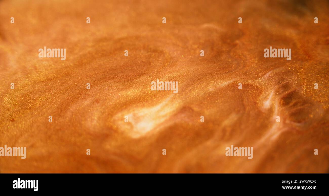 Glitter paint texture. Acrylic fluid spill. Defocused golden white ...