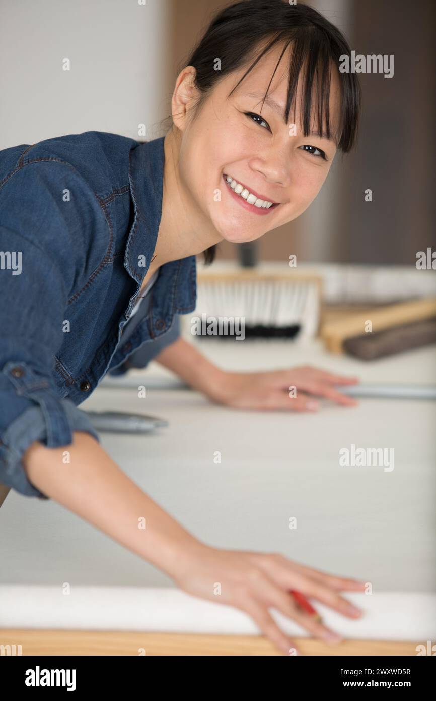 womans hands gluing wallpaper on the wall Stock Photo - Alamy
