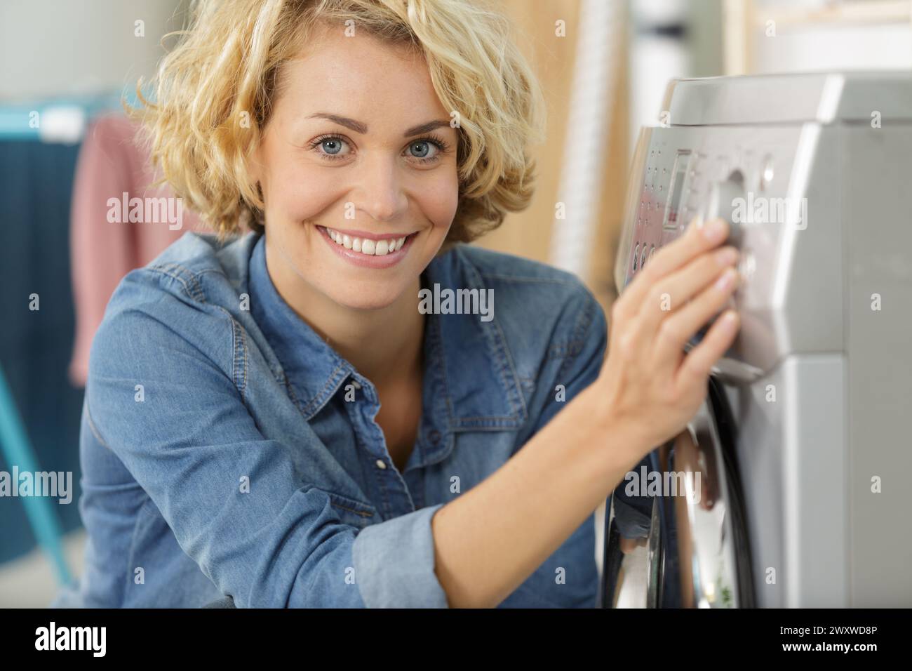 woman hand choosing program for washing machine Stock Photo - Alamy