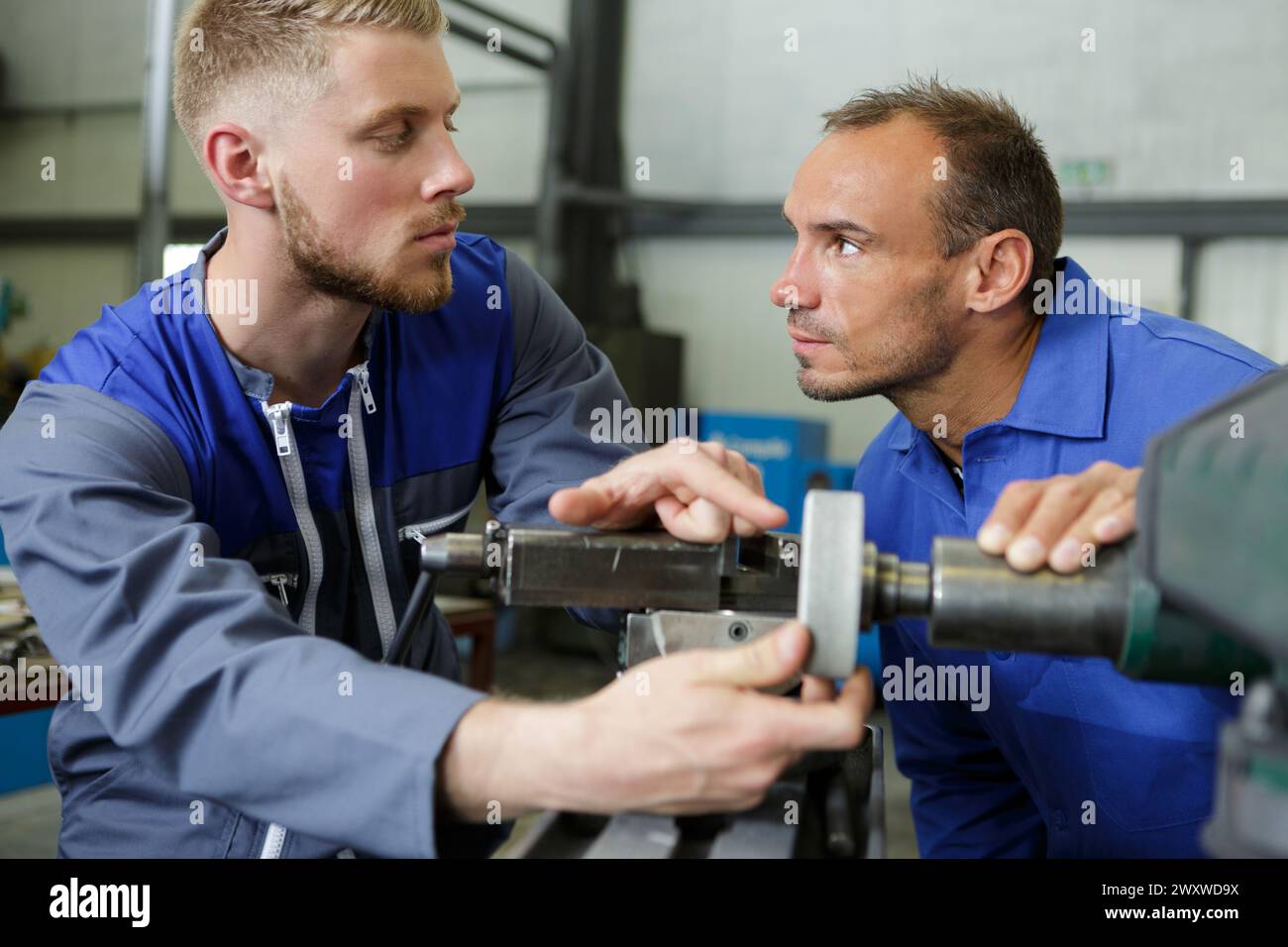 Worker setting up factory machine hi-res stock photography and images ...
