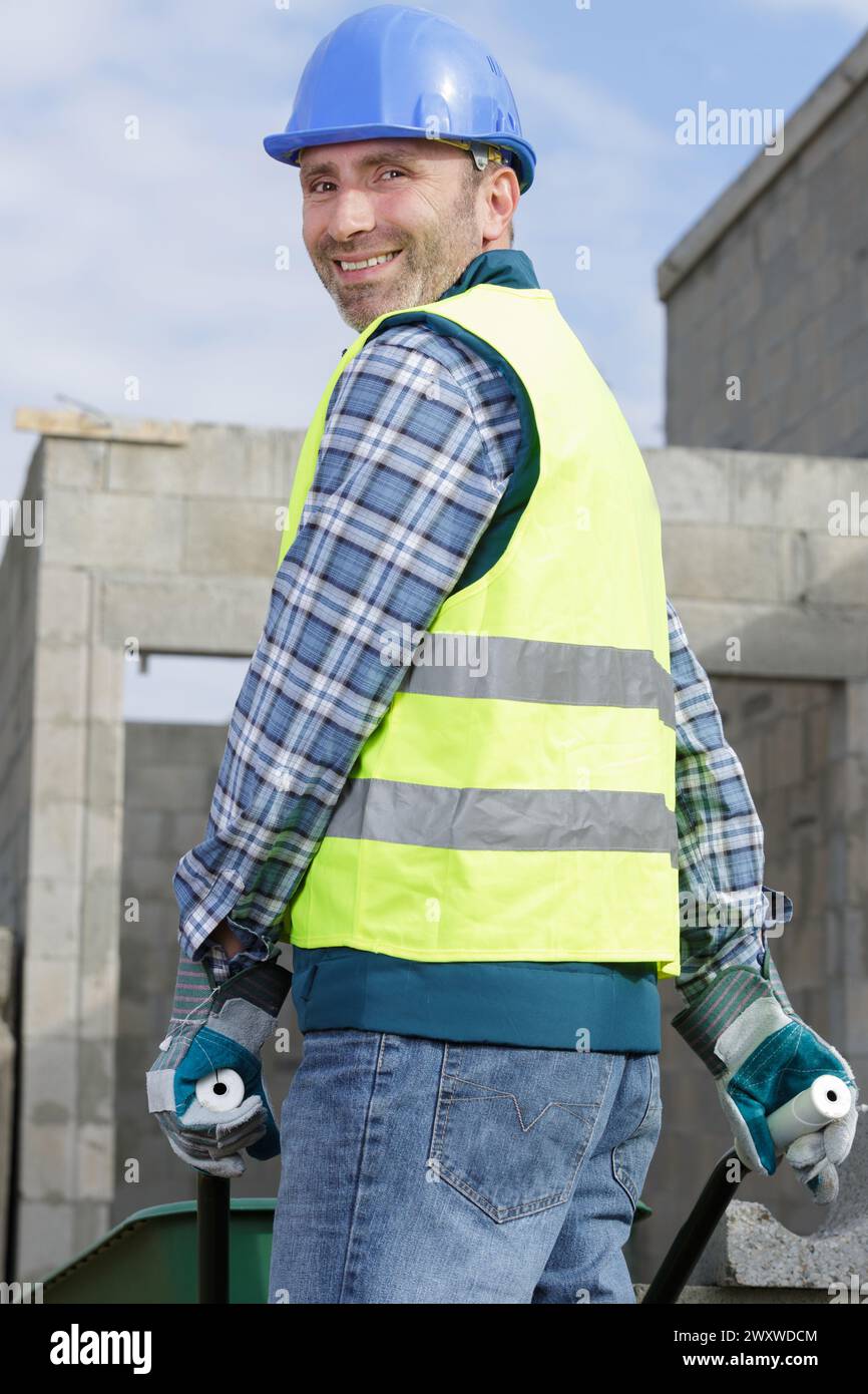 Man carrying heavy brick hi-res stock photography and images - Alamy