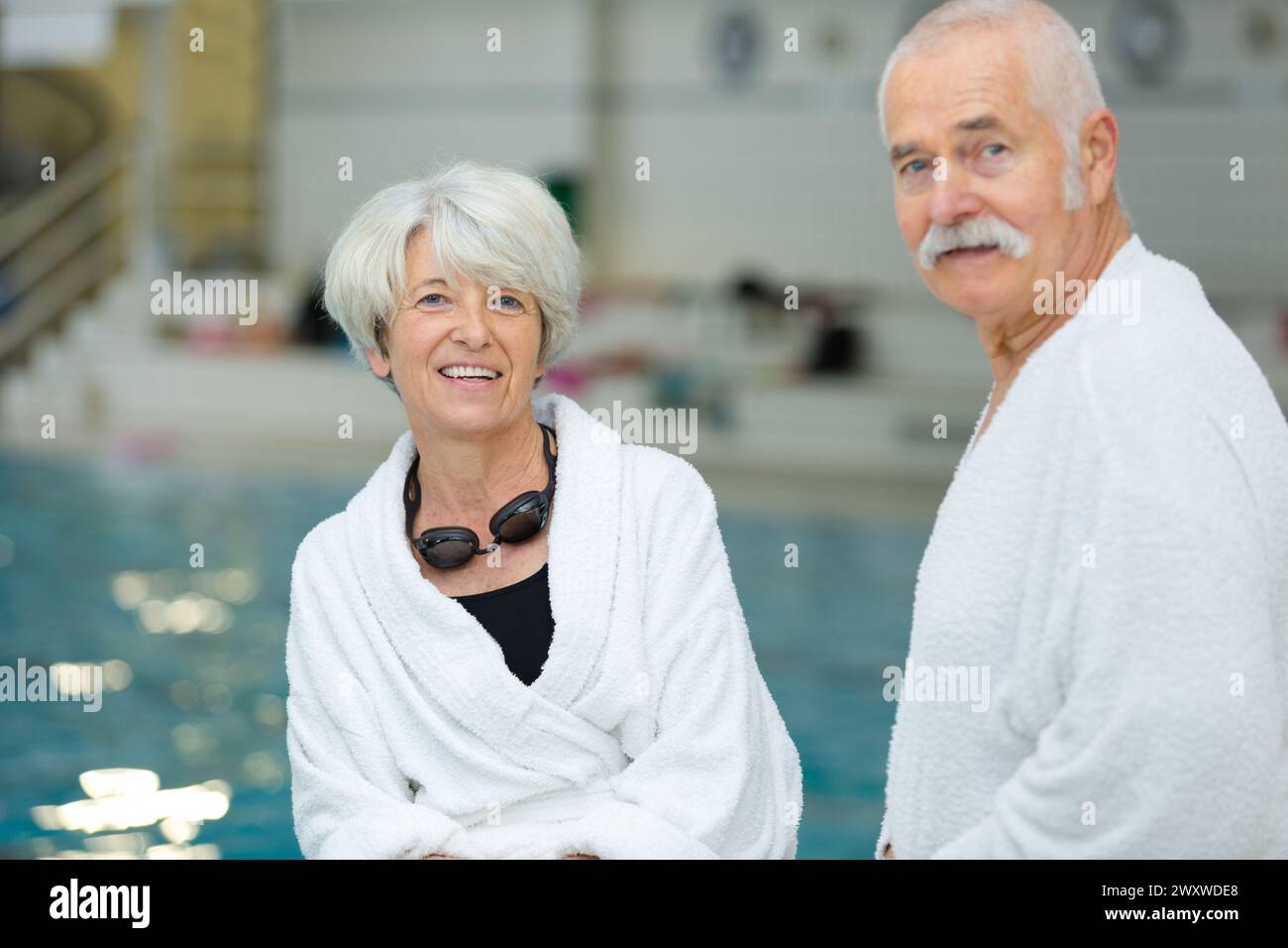 elderly couple on a pool deck Stock Photo - Alamy
