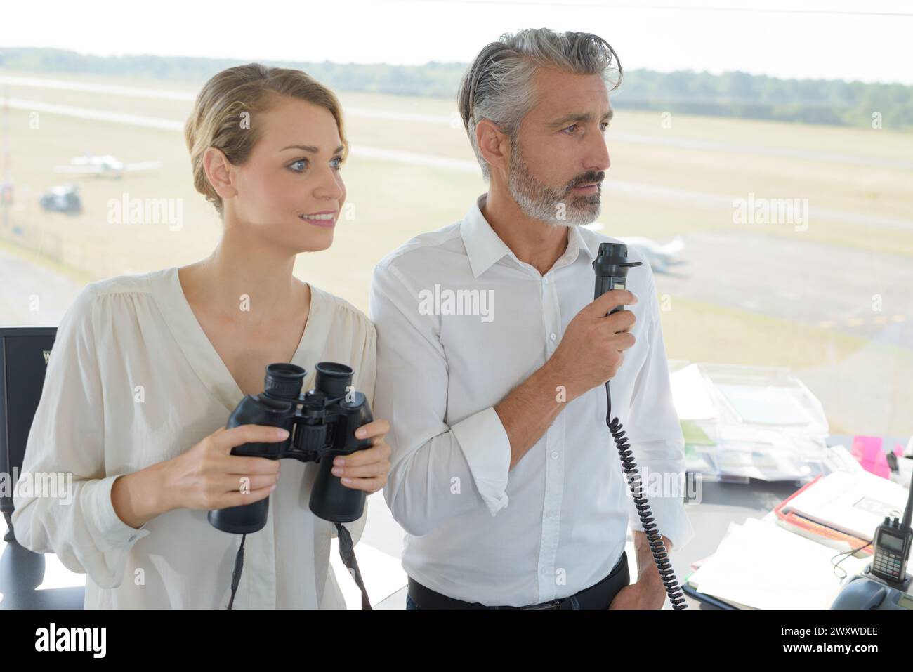 man in control tower making announcement Stock Photo - Alamy