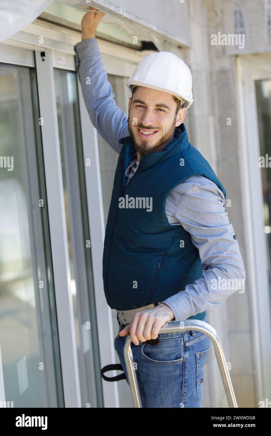 man reaching on top of ladder climbing Stock Photo - Alamy