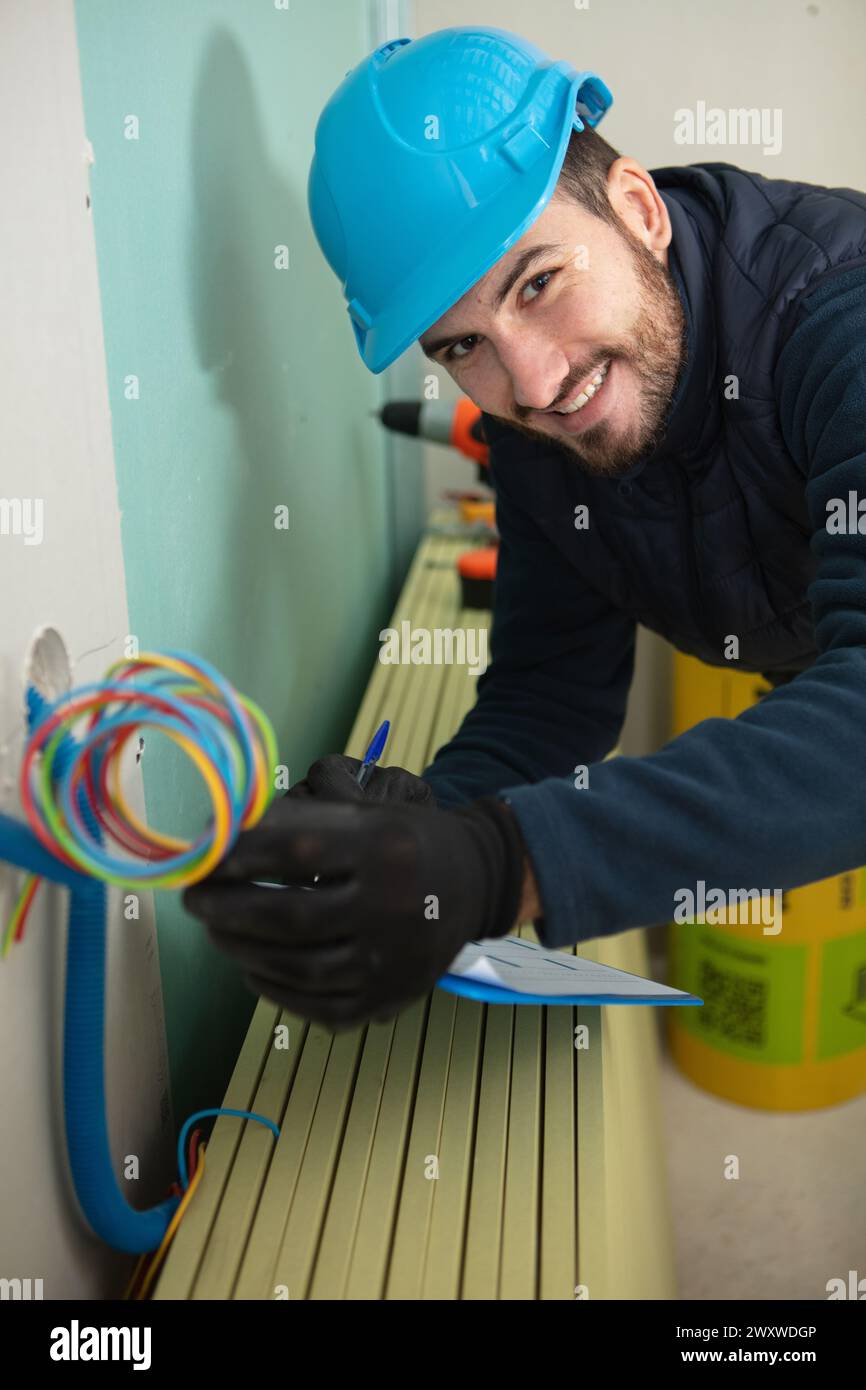 electrician checks electrical wires in wall Stock Photo - Alamy