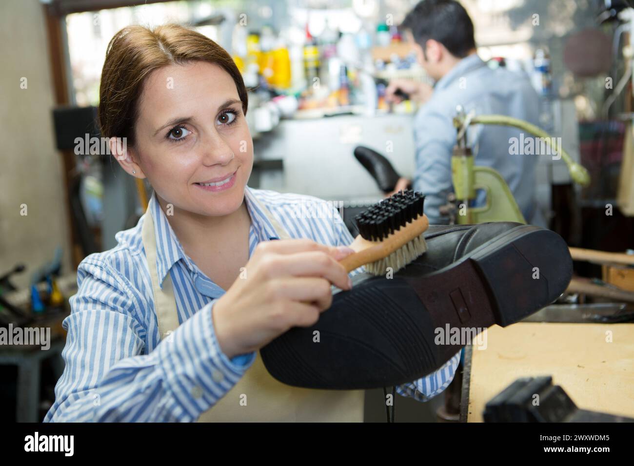 woman working in a shoe making store Stock Photo - Alamy
