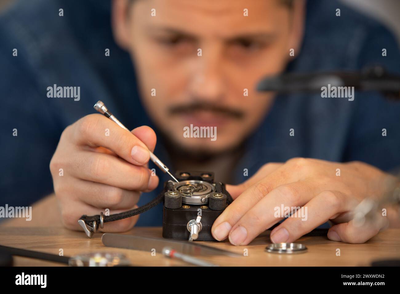 man is fixing a watch Stock Photo - Alamy