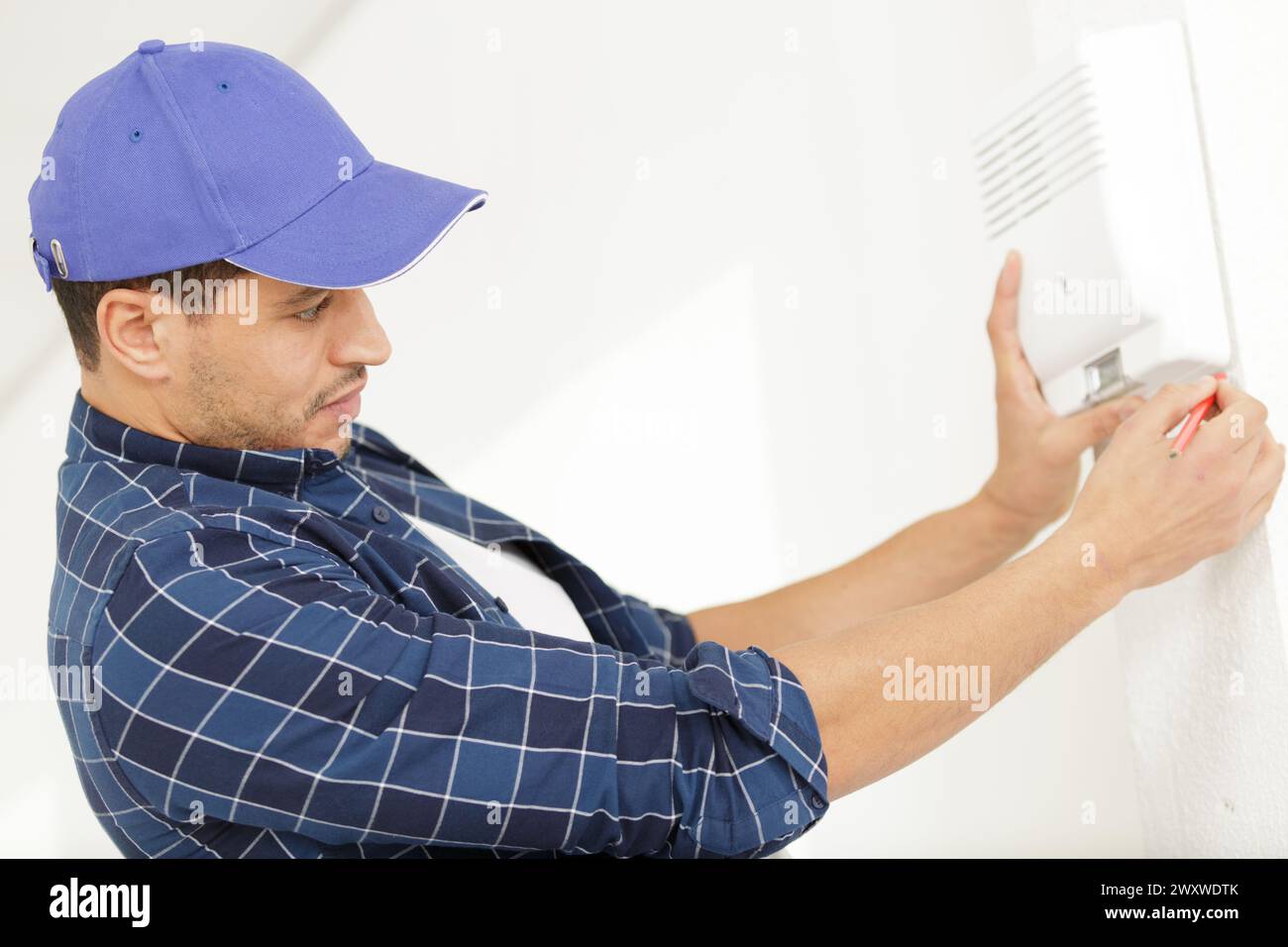 construction worker puts a finishing touch on the wall Stock Photo - Alamy