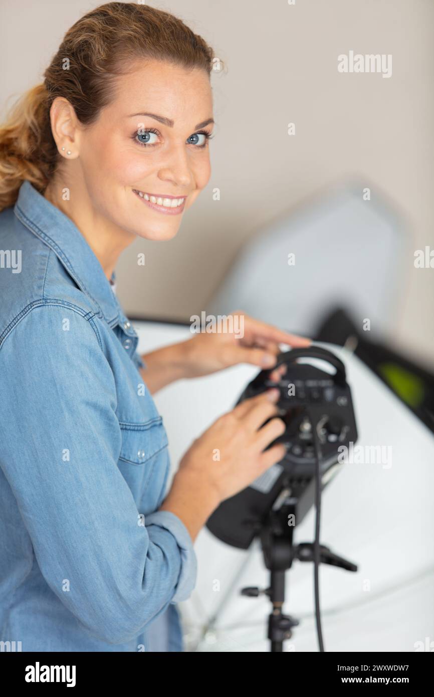 female photographer setting up camera in studio Stock Photo - Alamy