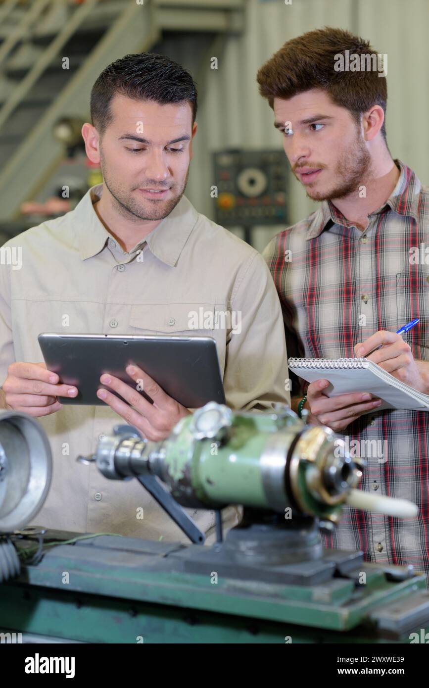 apprentice working on milling machine Stock Photo - Alamy