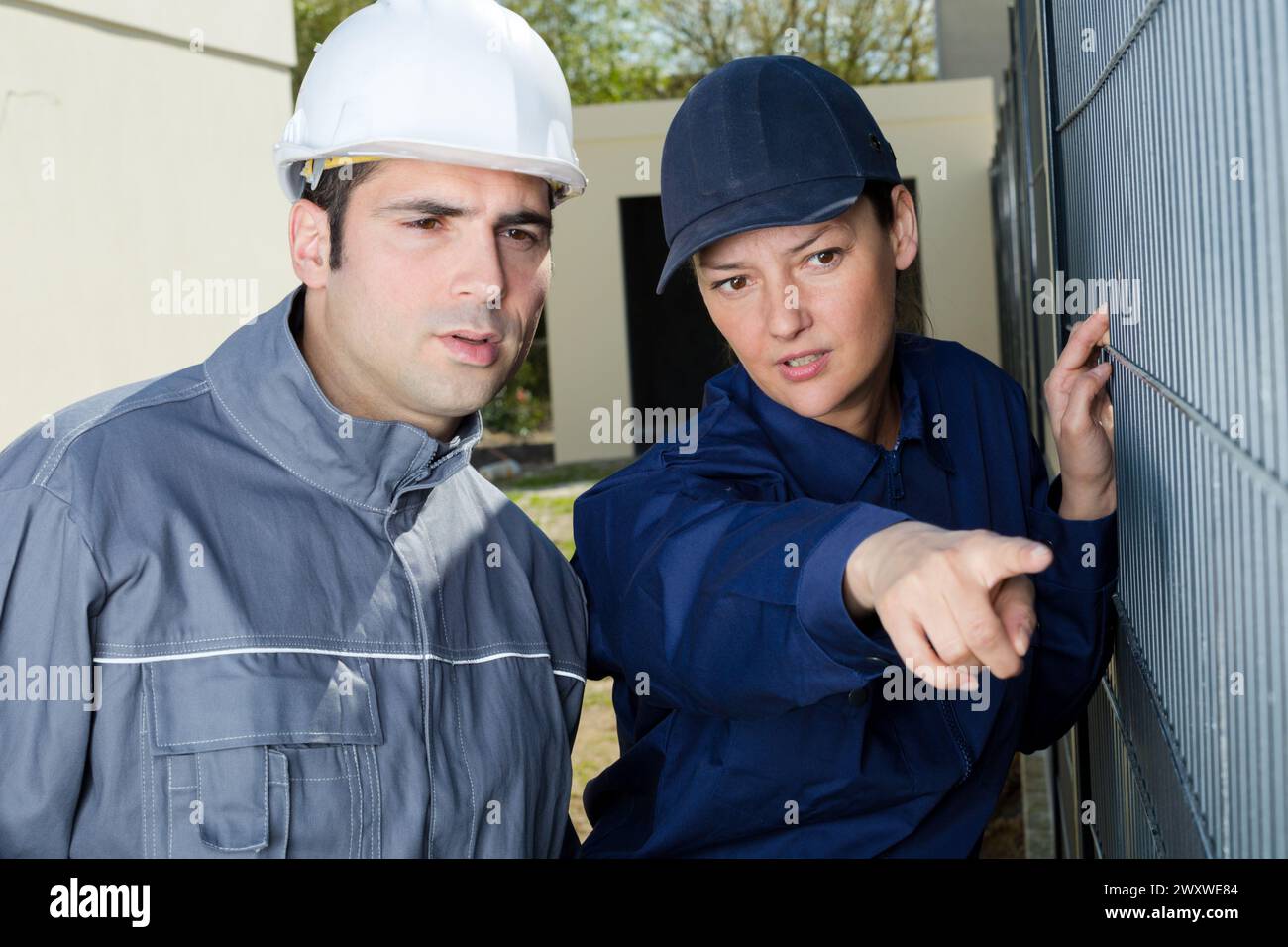 female builder pointing at something outdoors Stock Photo - Alamy