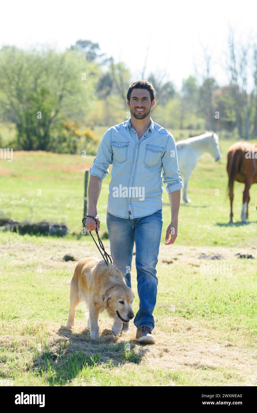man walking with his dog Stock Photo - Alamy