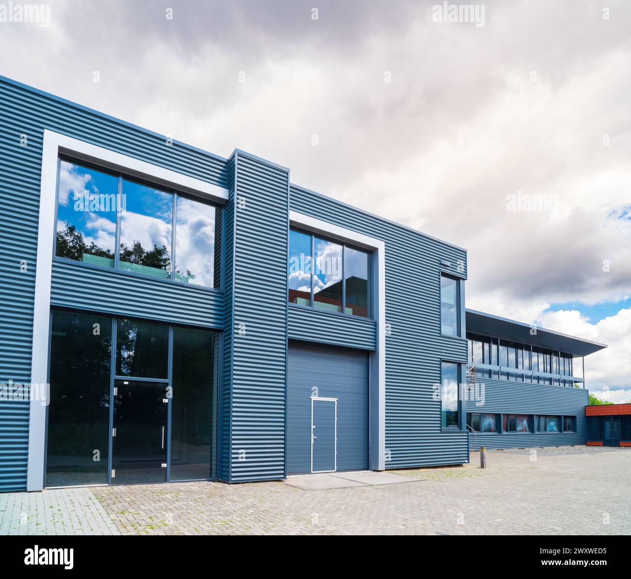 exterior of a modern warehouse with office unit Stock Photo - Alamy