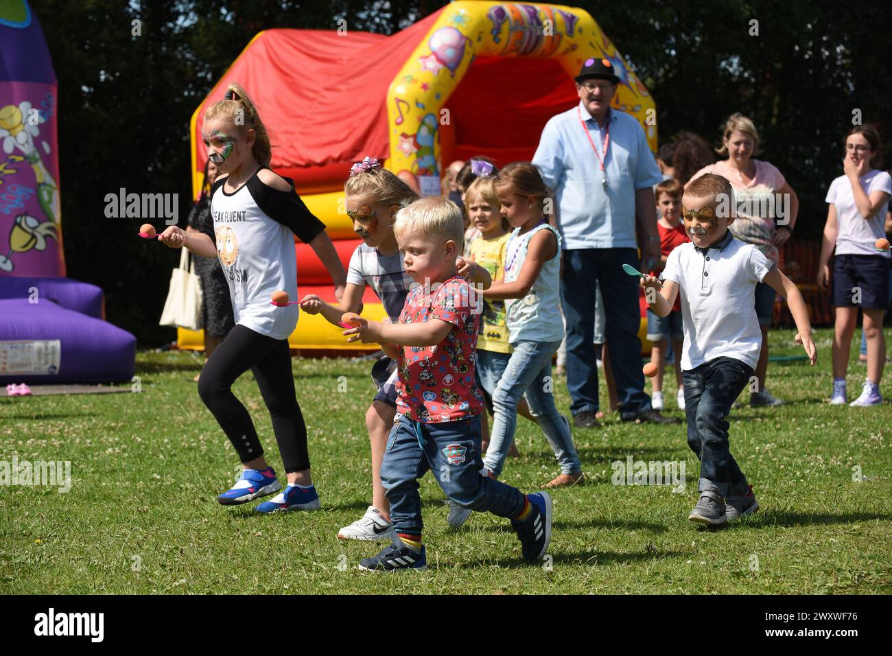 Children playing egg and spoon race in the park in Nechells, Birmingham ...