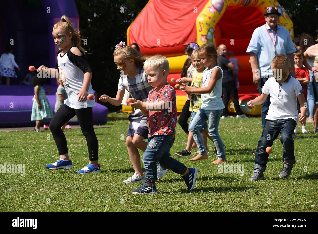 Children playing egg and spoon race in the park in Nechells, Birmingham ...