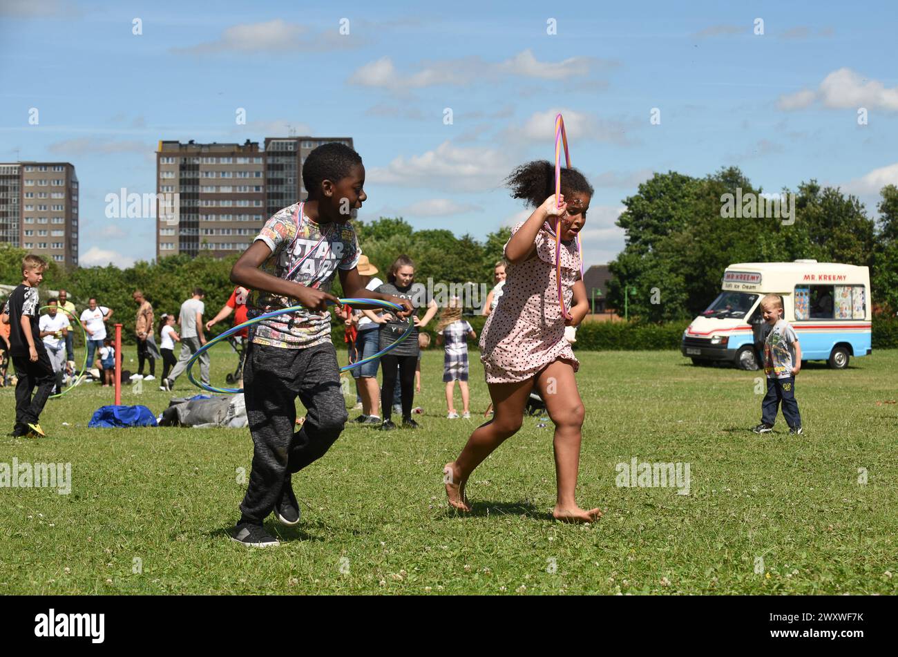 Children playing hula hoop in the park in Nechells, Birmingham Stock ...