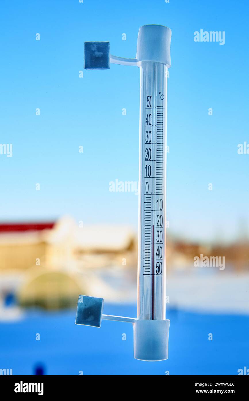 Low air temperature is indicated by an outdoor thermometer with scale ...