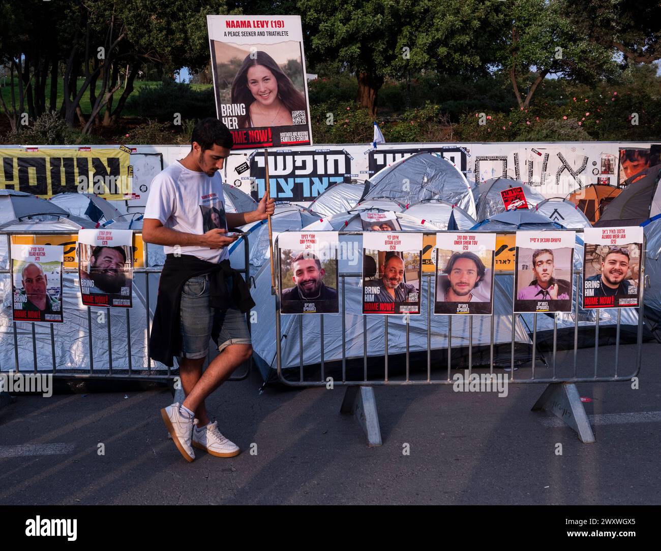 A protestor holds a sign to release a hostage as he stands among may ...