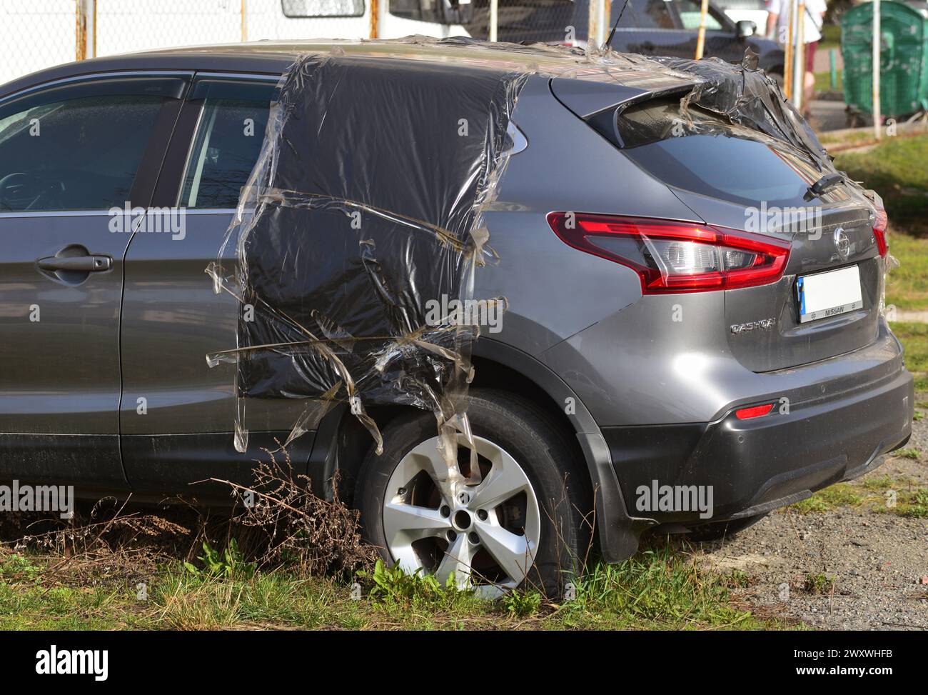 Wrecked gray crumpled car from the left side after accident with a ...
