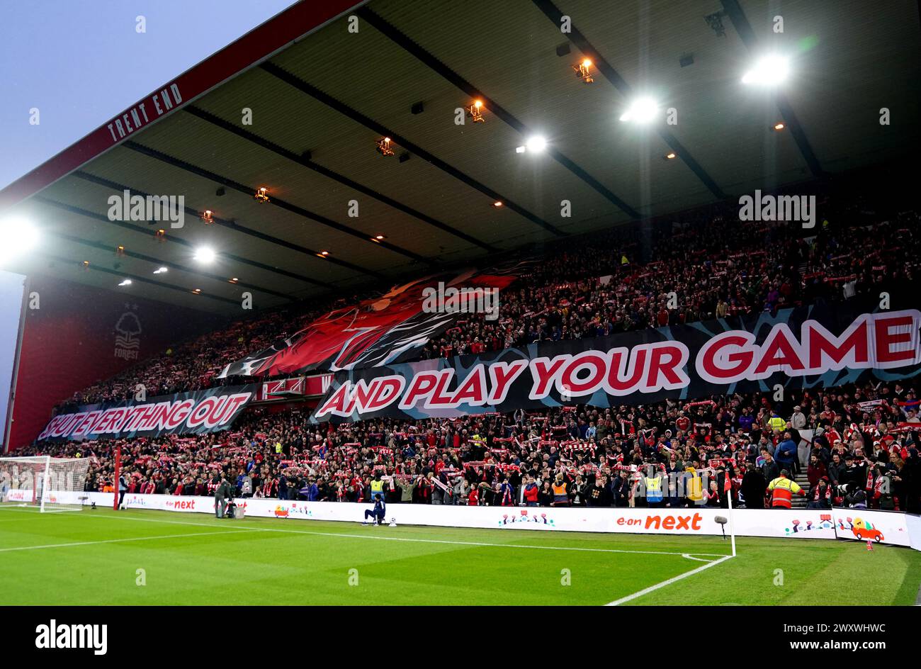 Fans hold up banners in the stands ahead of the Premier League match at ...
