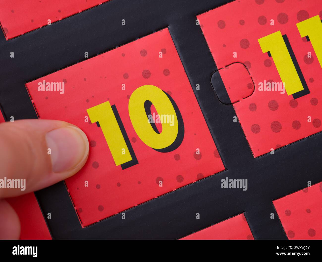 A woman hand ready to open the door with number 10 on the advent ...