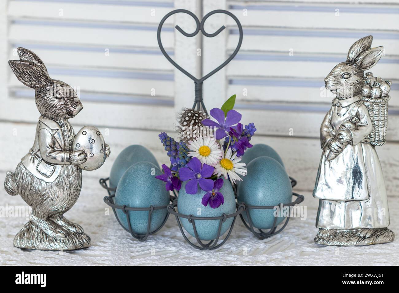 easter arrangement with easter bunny and blue coloured eggs decorated ...