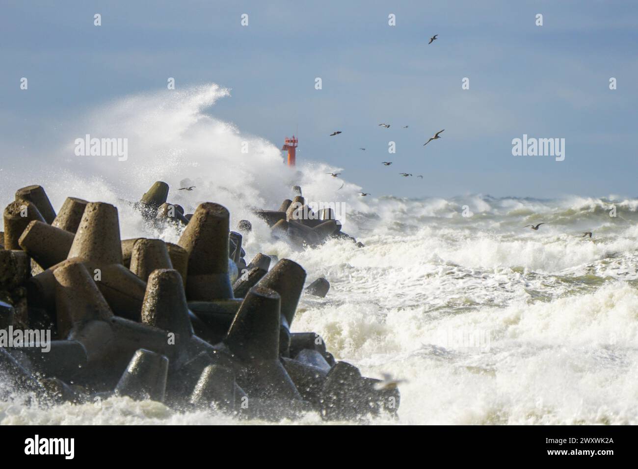 Storm at sea, high waves crashing against the concrete breakwaters of ...