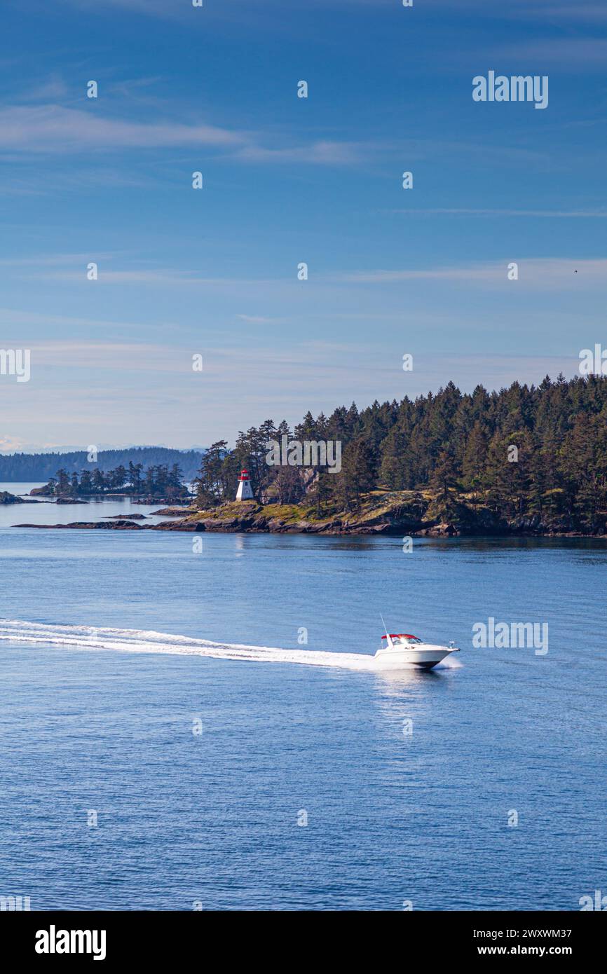 Speedboat passing Portlock Point lighthouse on Prevost Island in ...