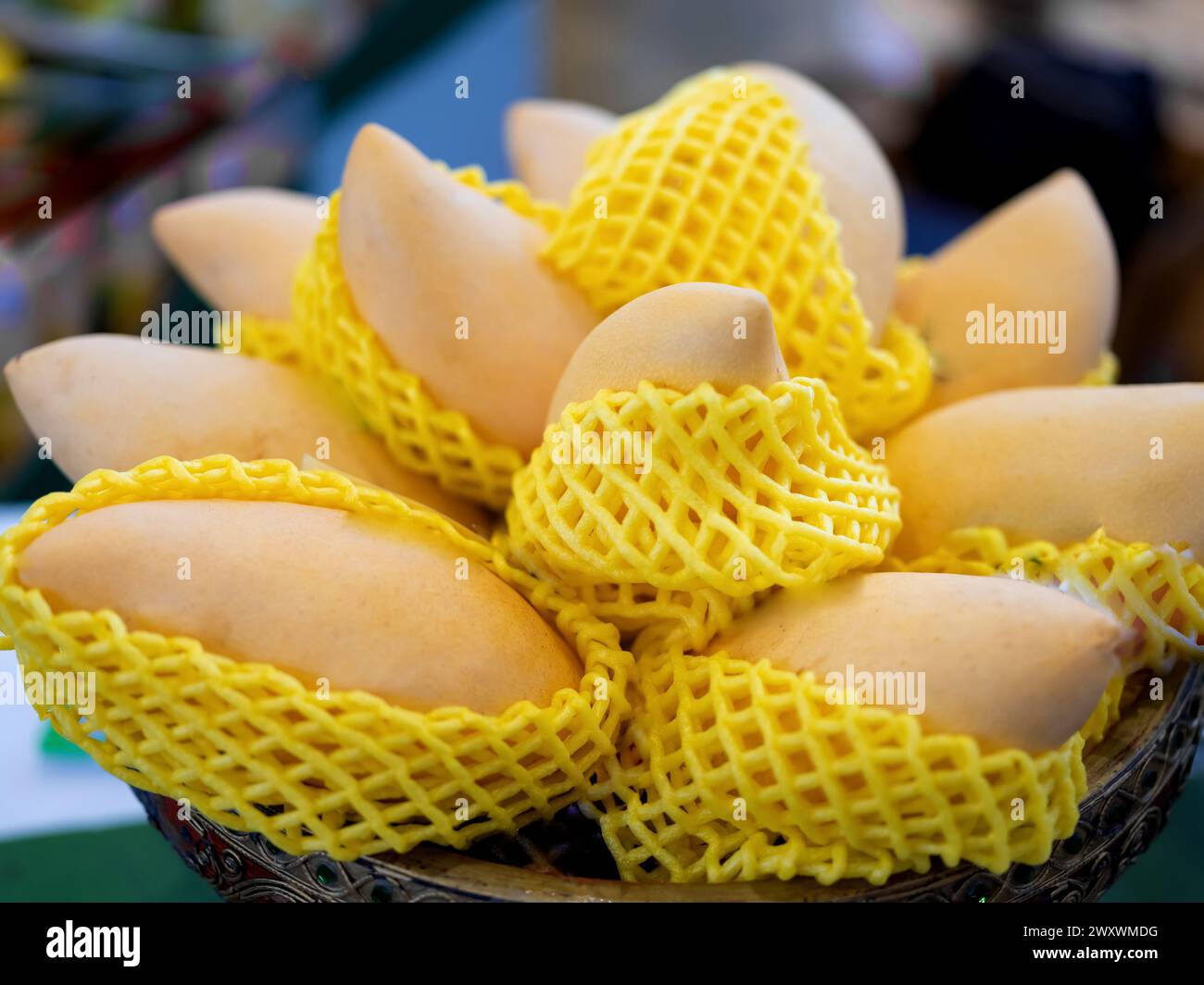 Stack of ripe yellow mangoes on in plastic packaging. Fruit and ...