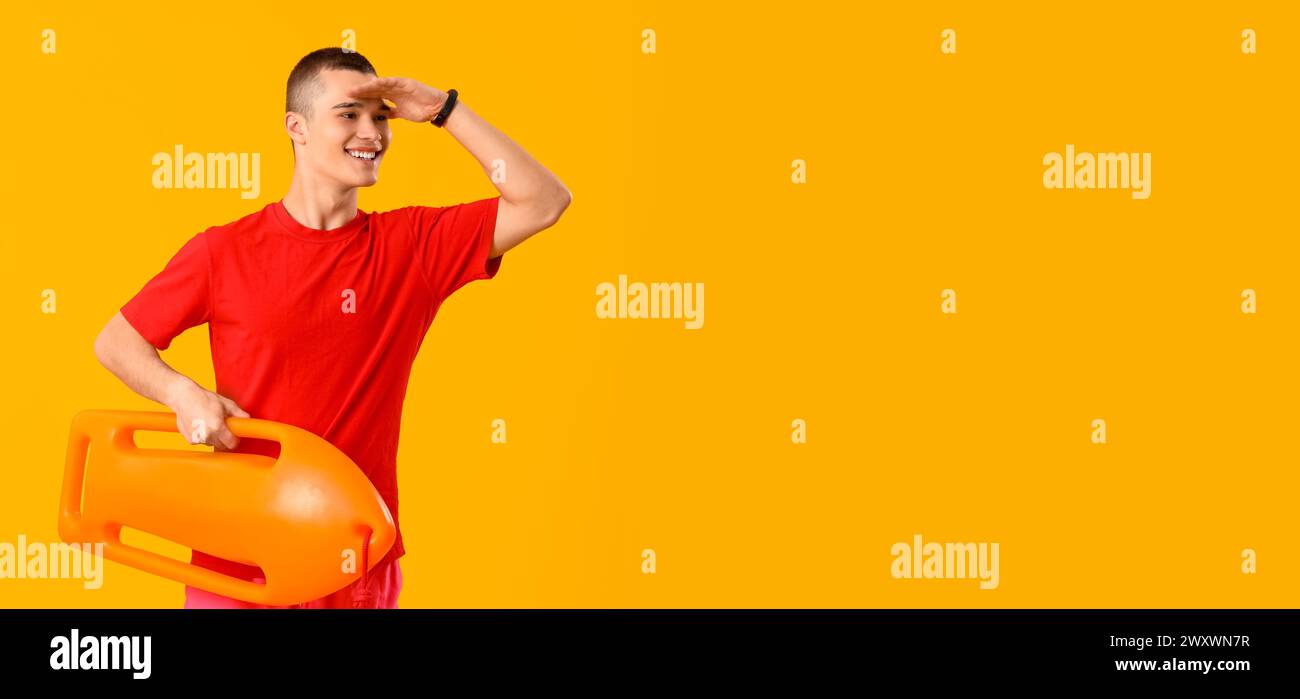 Male lifeguard with rescue float on yellow background with space for ...