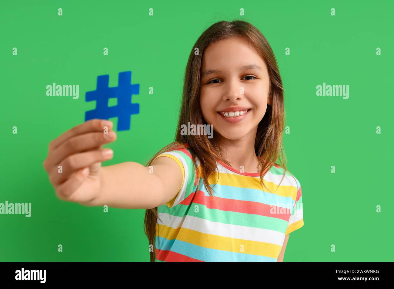 Cute teenage girl with hashtag on green background Stock Photo - Alamy