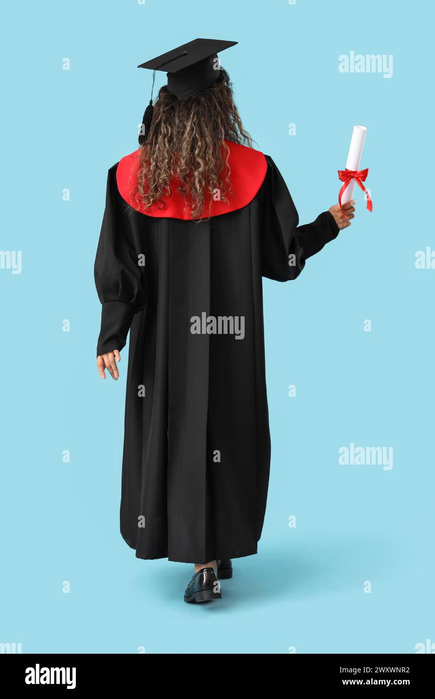 Female graduate student with diploma on blue background, back view ...