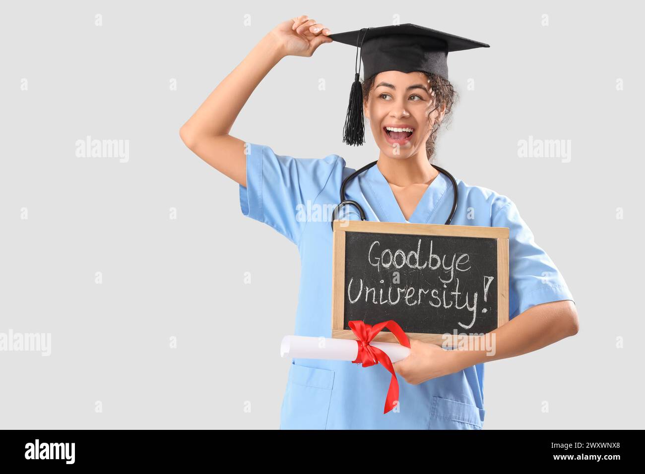 African-American female medical graduate student holding chalkboard ...