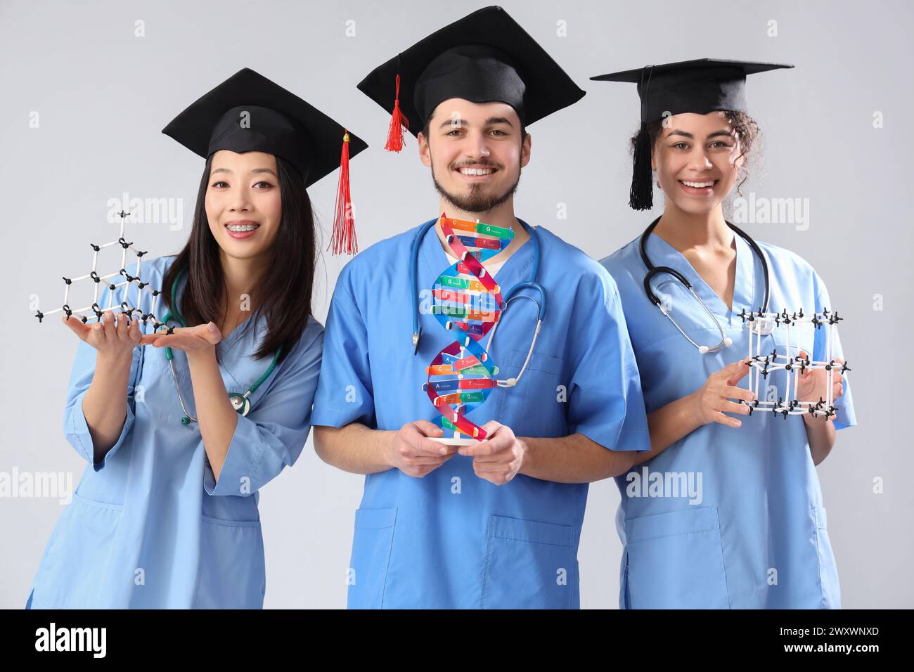 Medical graduate students with DNA and molecular models on white ...