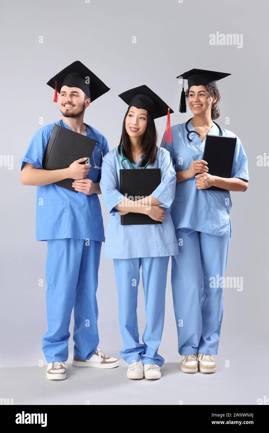 Medical graduate students with diplomas on white background Stock Photo ...