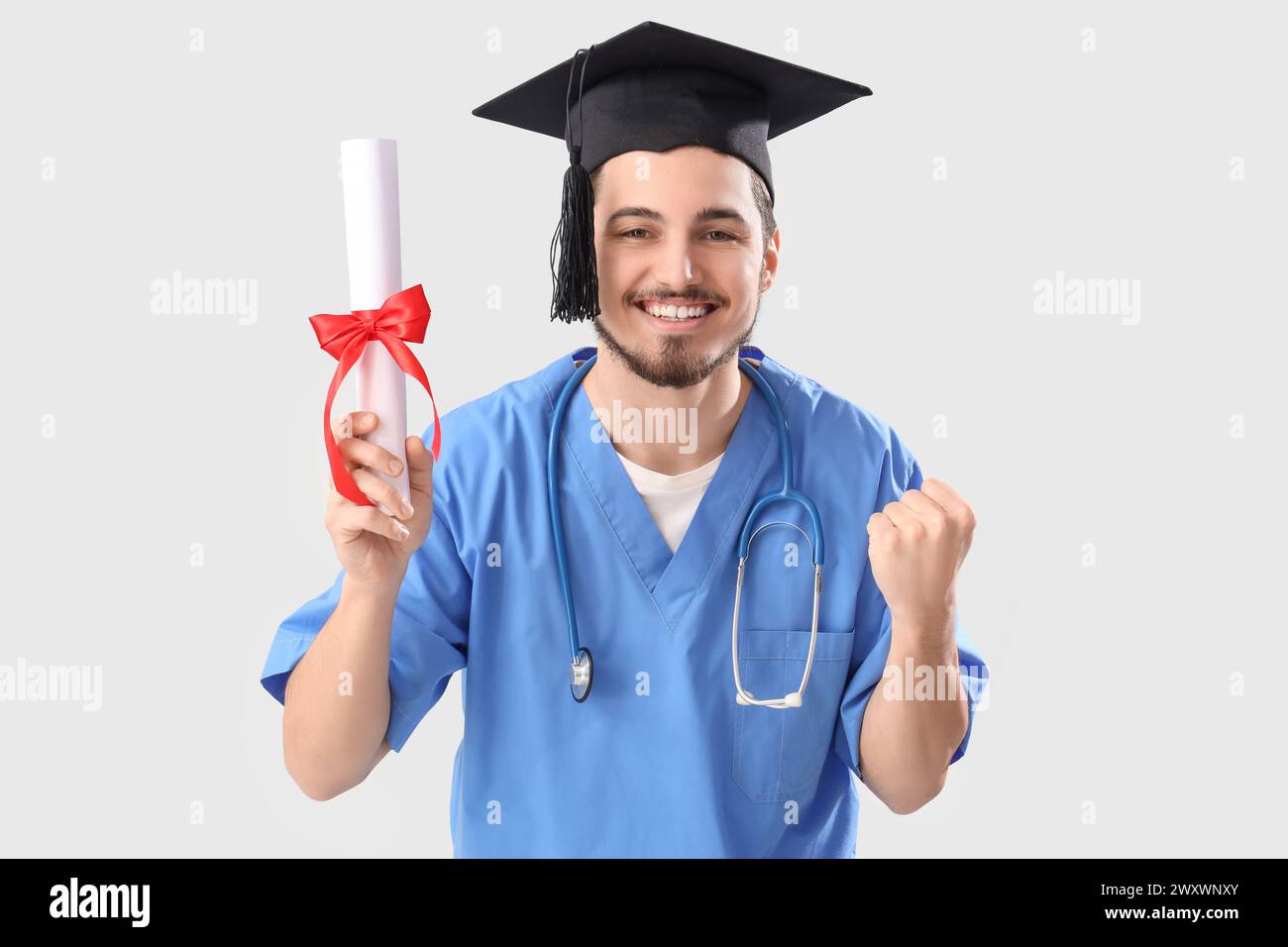 Male medical graduate student with diploma on white background Stock ...